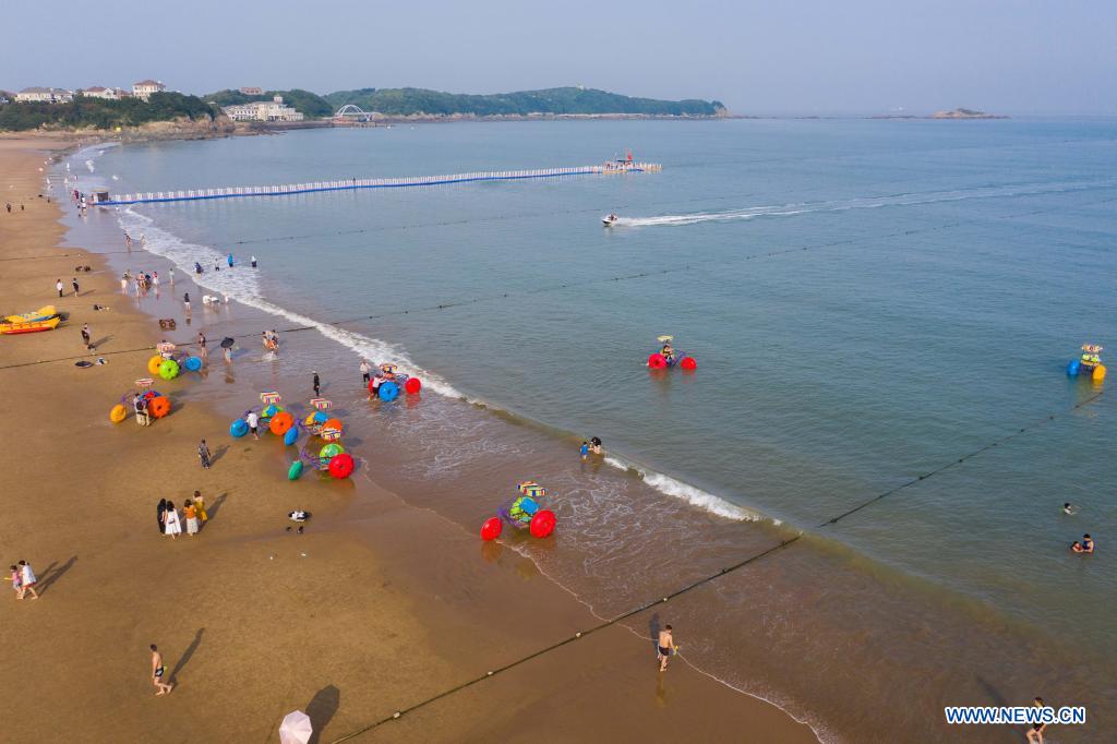 Tourists enjoy seaside time at Nansha beach resort in Zhoushan, E China ...